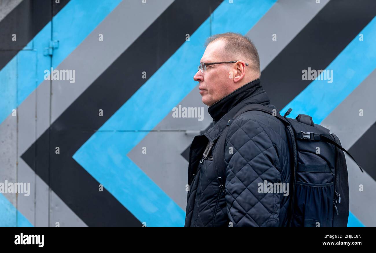 Mature ambitious man going and looking forward over black and gray ...