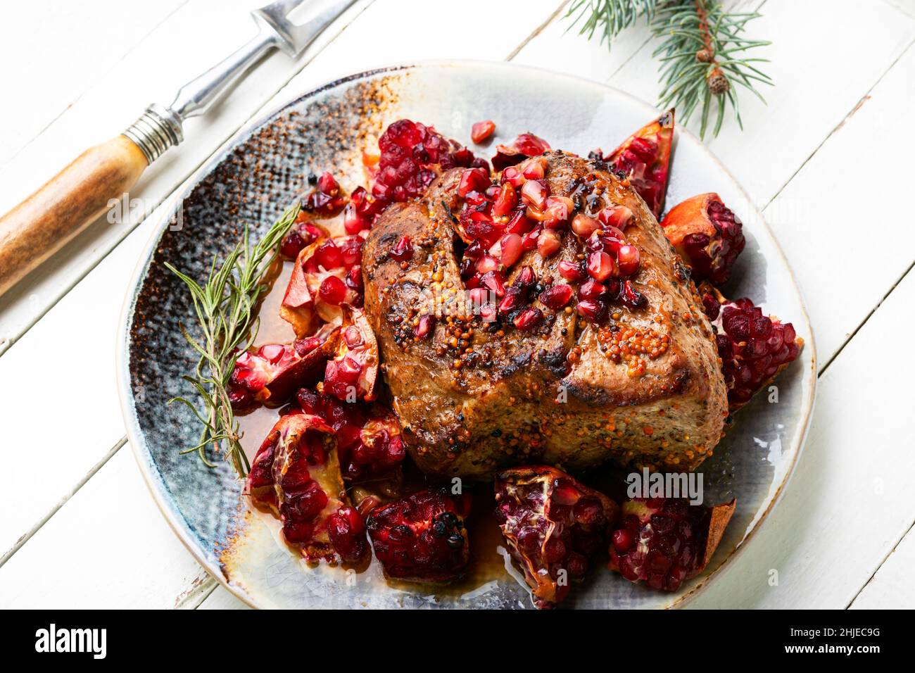 Delicious piece of meat fried with pomegranate Stock Photo - Alamy