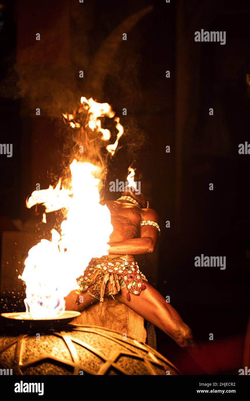 Back shot of a performer Moroccan fire breather, in Marrakech at night ...