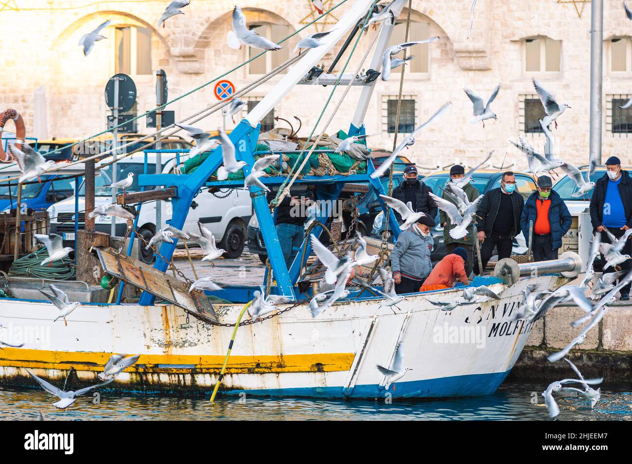 Old fishing boat parked near the quay of the port selling fresh just ...