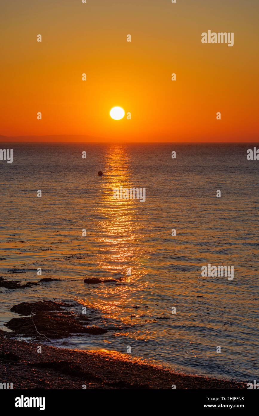 Bright sunset with a streak of sunlight going across the channel Stock ...