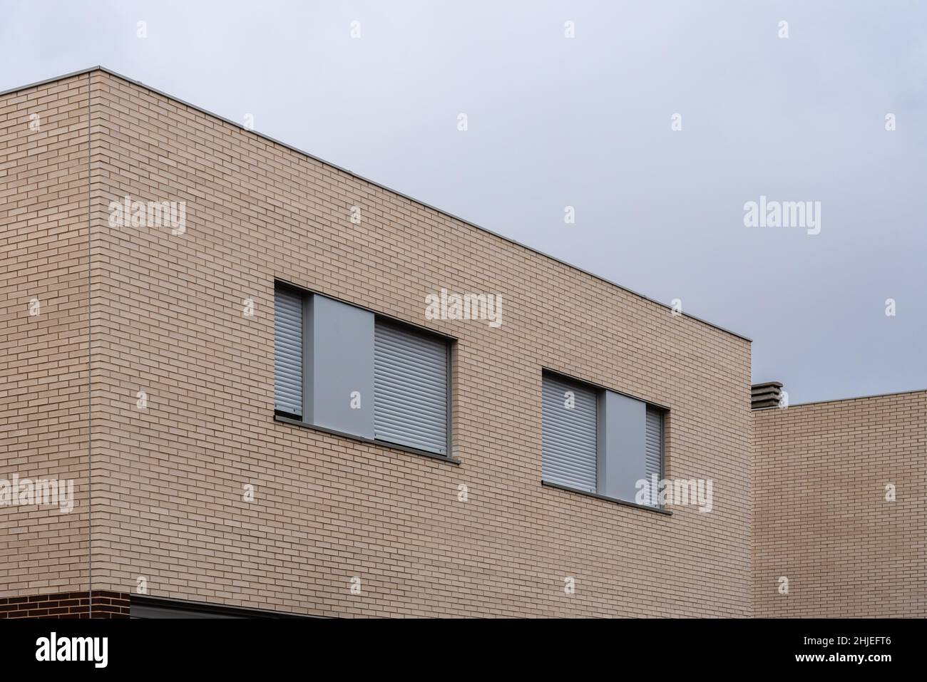 Detail of window of contemporary row houses with brick facade ...