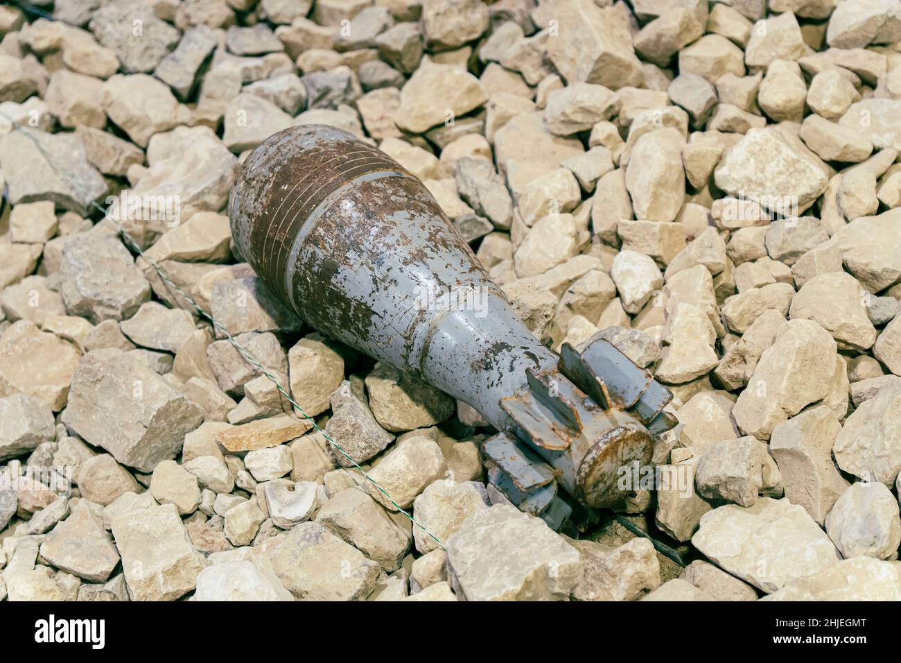 An unexploded mortar mine lying on the rocks. Clearance of unexploded ...