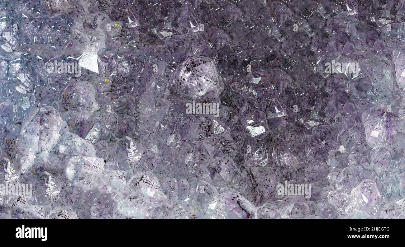 Quartz with mineral inclusions in the studio in front of black ...