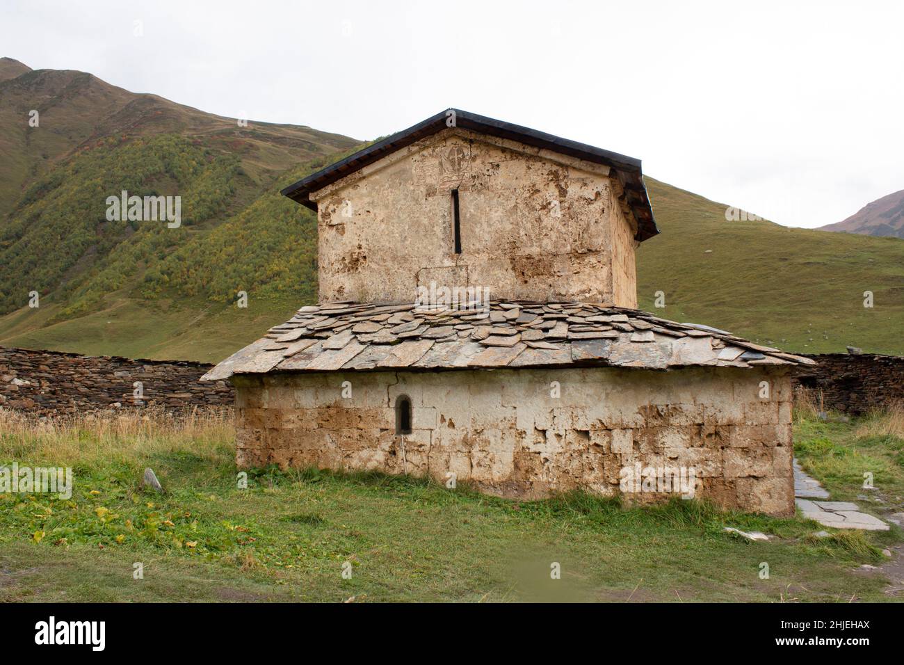 Ancient stone monastery high in the Caucasus mountains on a summer day ...