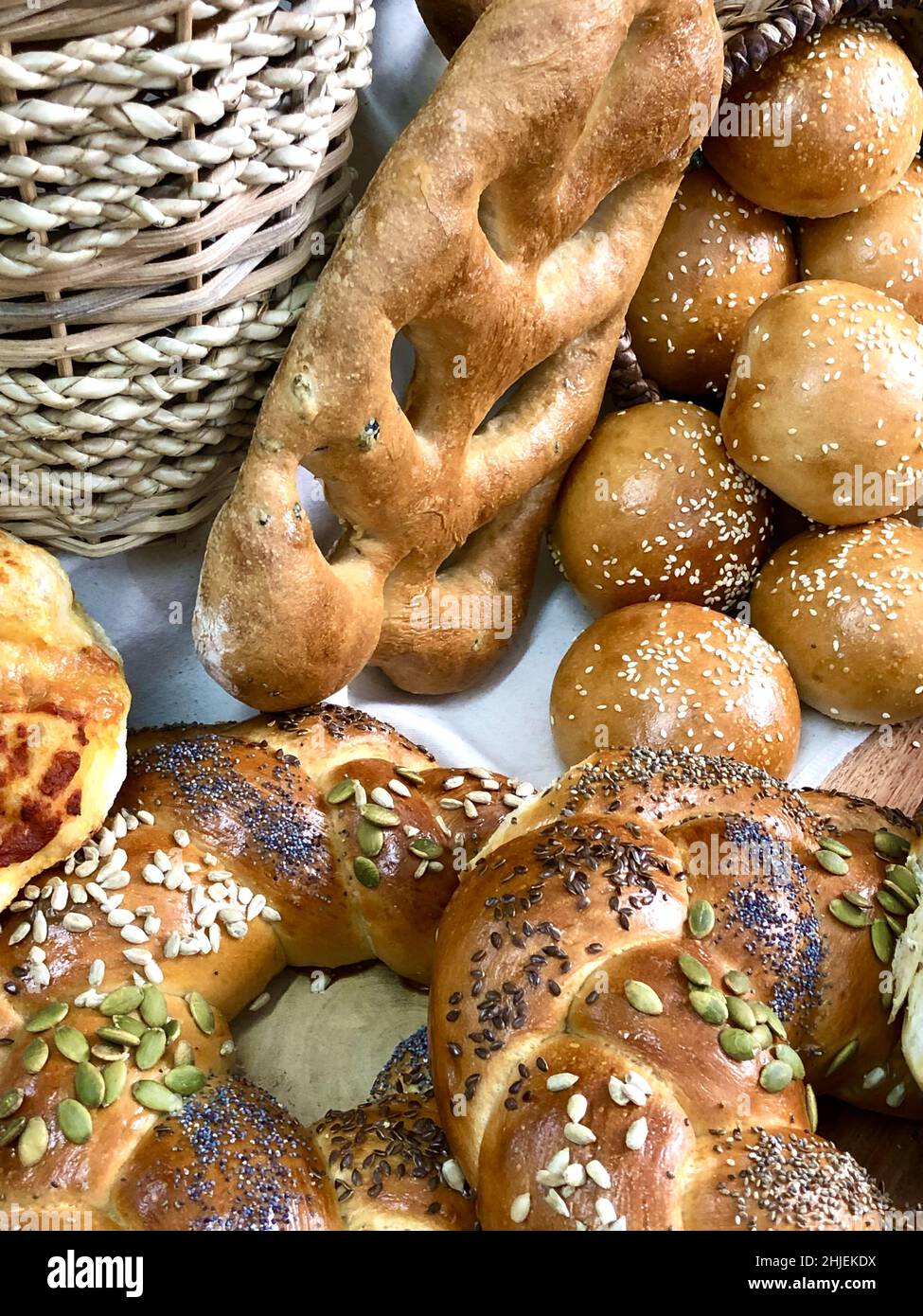 Vertical shot of different types of bread on the white background Stock ...