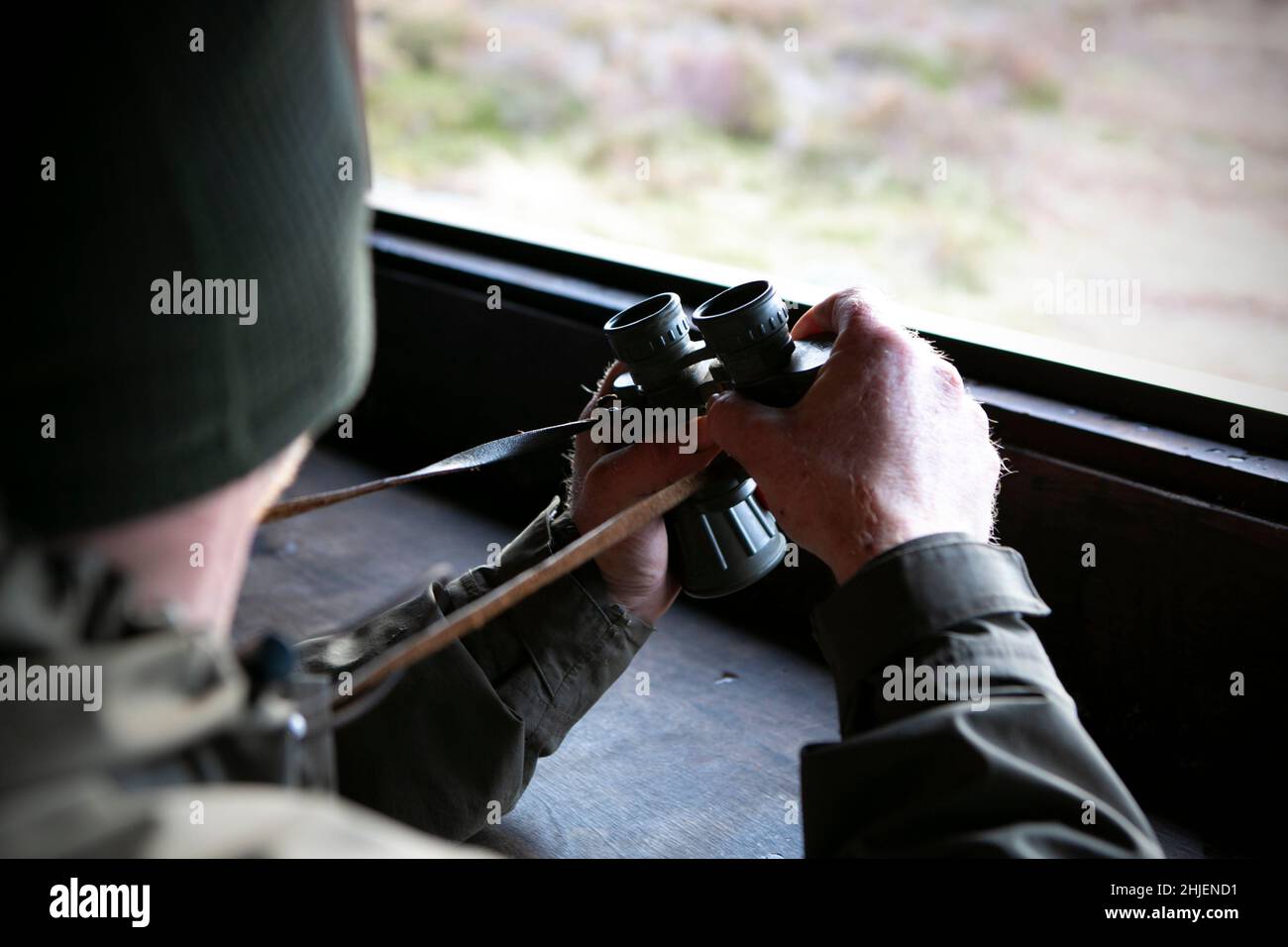 Gamekeeper Gary Taylor holding his binoculars in the Druids’s ...