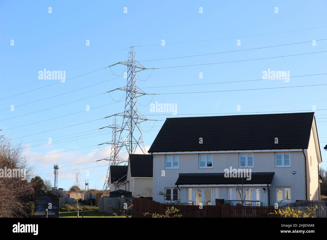 Electric Pylons and a 5G Mast Behind Houses in a Residential Area in ...