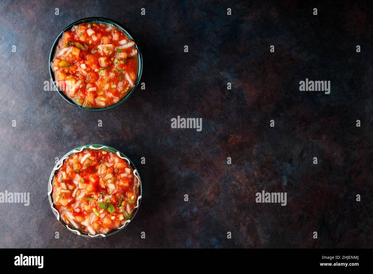 Bowl of mexican salsa sauce on a dark background. Traditional Latin ...