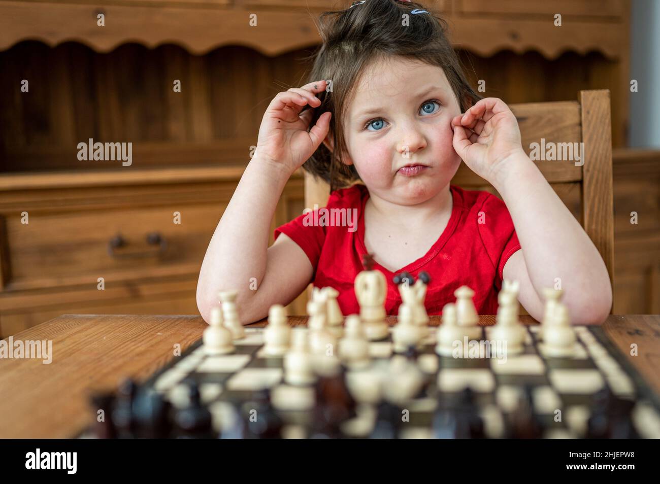 A smart little girl playing chess Stock Photo - Alamy