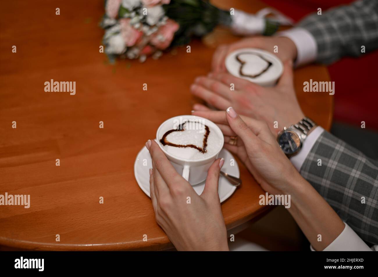 coffee cups heart latte art, in the hands of a man and a woman ...