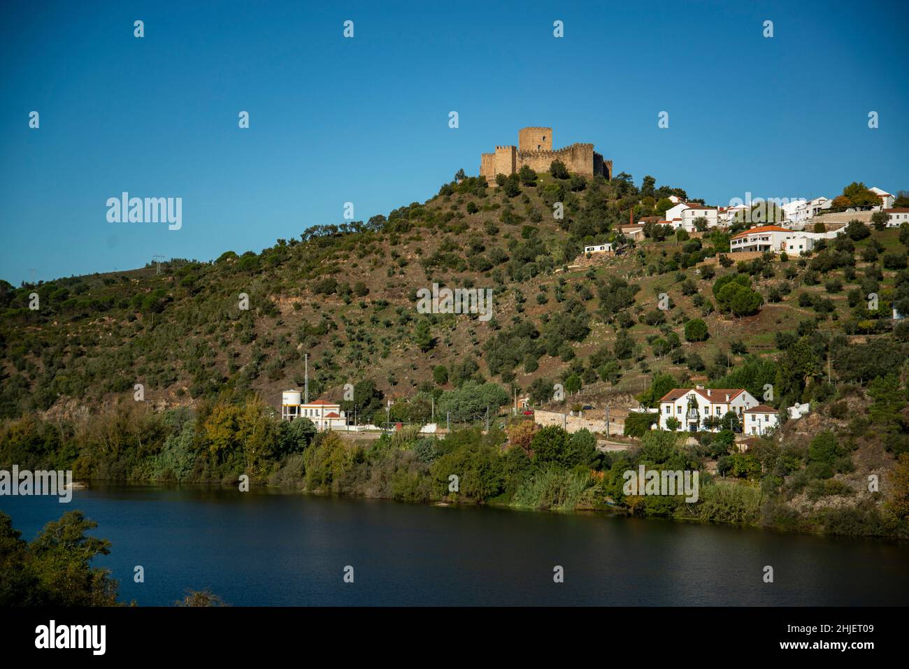 a view with the Castelo de Belver with the Town of Belver at the Rio ...