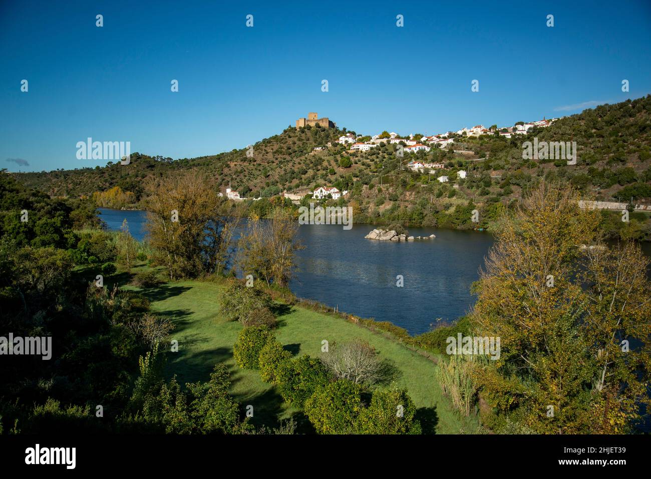 a view with the Castelo de Belver with the Town of Belver at the Rio ...