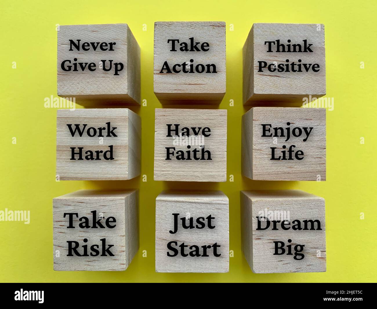 Top view of wooden blocks with positive words and yellow background ...