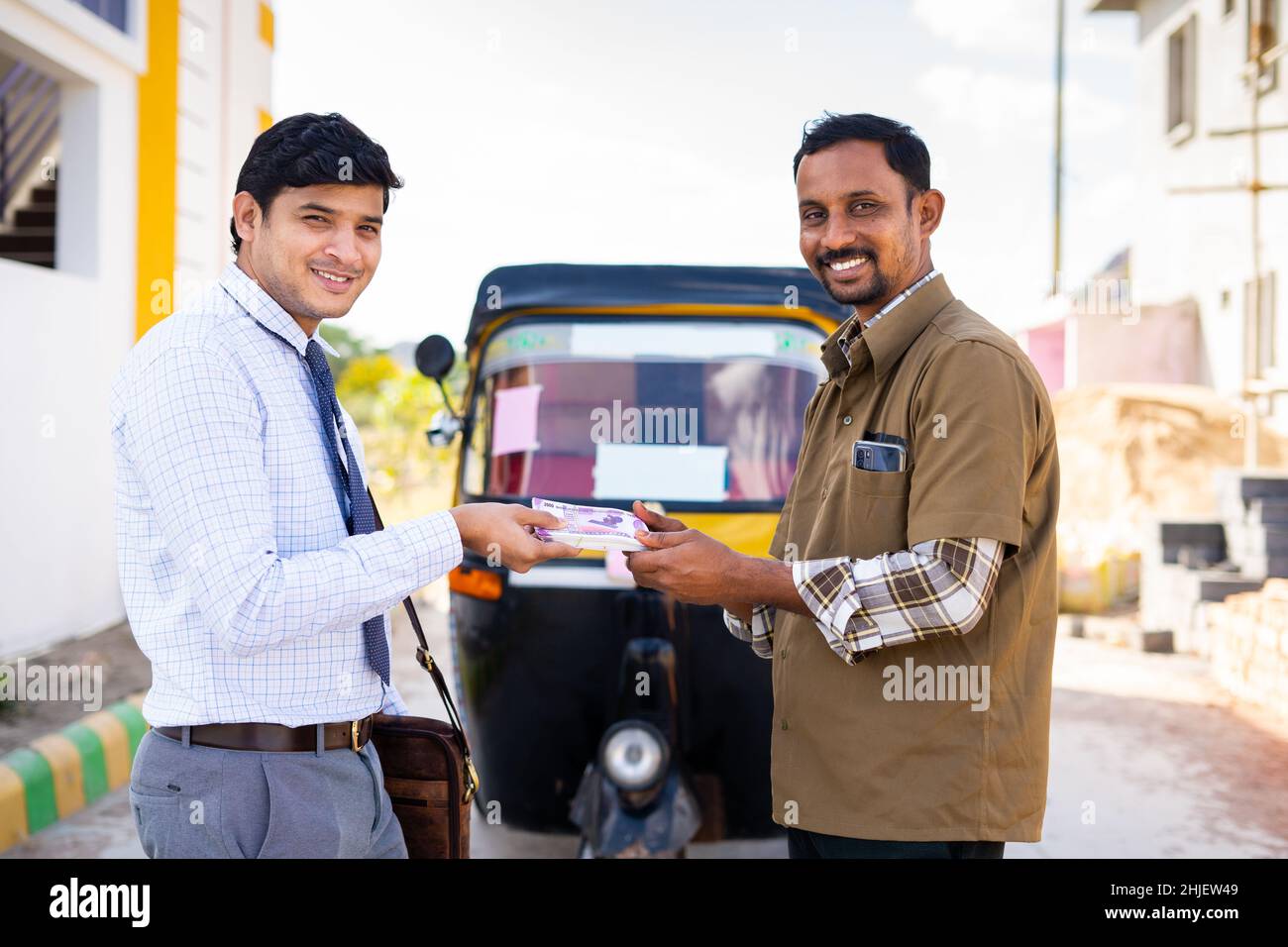 young indian auto rikshaw driver reciving loan money from banker in ...