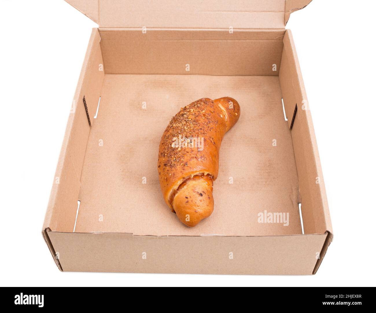 Delicious crispy croissant in cardboard box. Isolated on a white ...