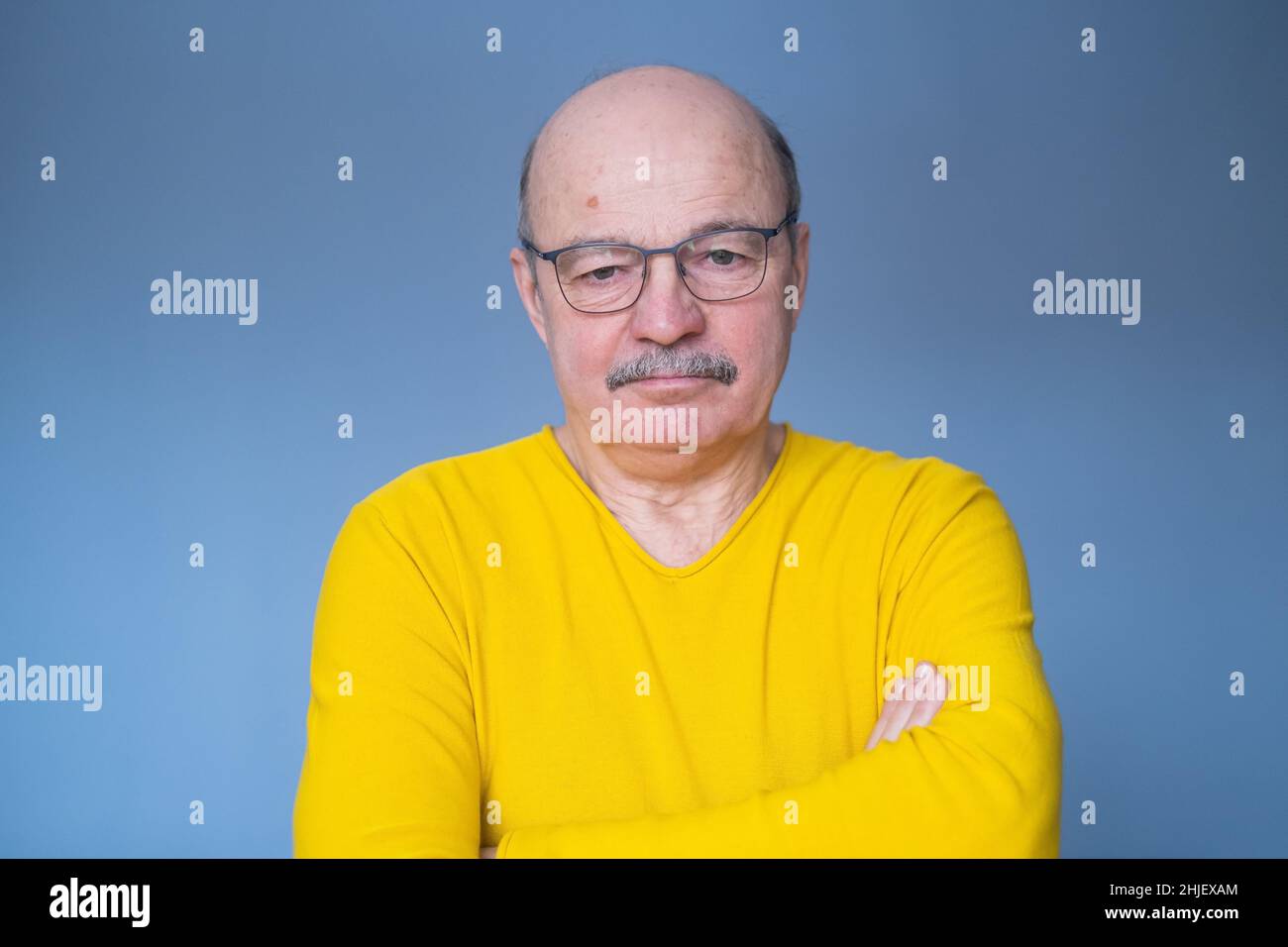 Sad senior hispanic man in glasses looking down being alone Stock Photo ...