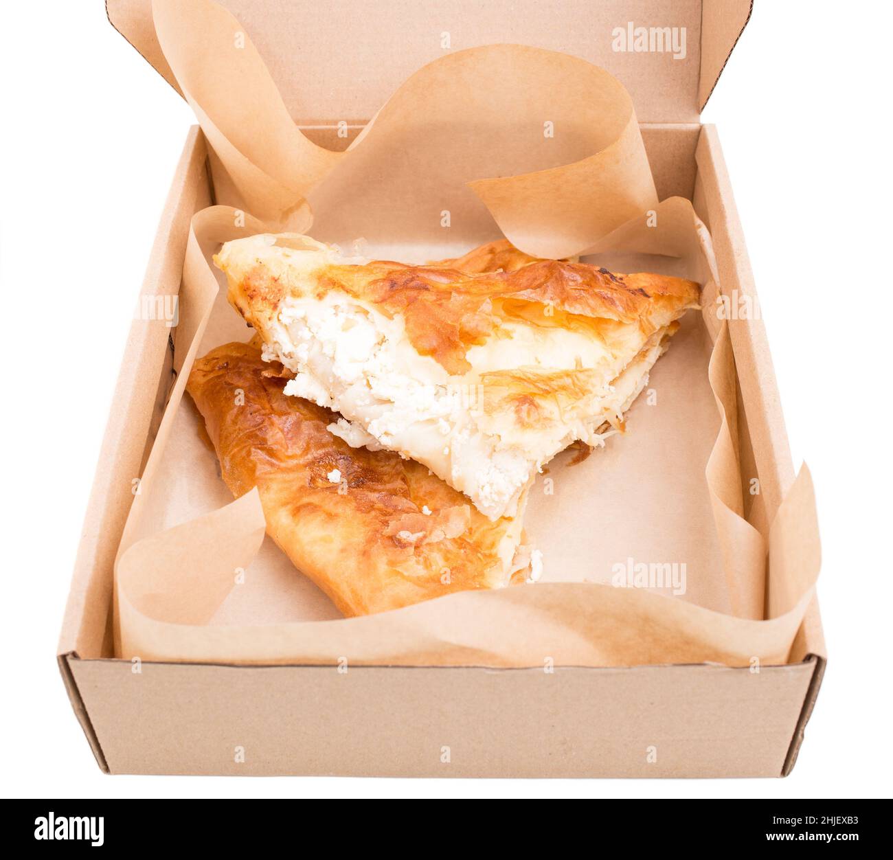 Heat puff cakes filled with a curd cheese in cardboard box. Isolated on ...