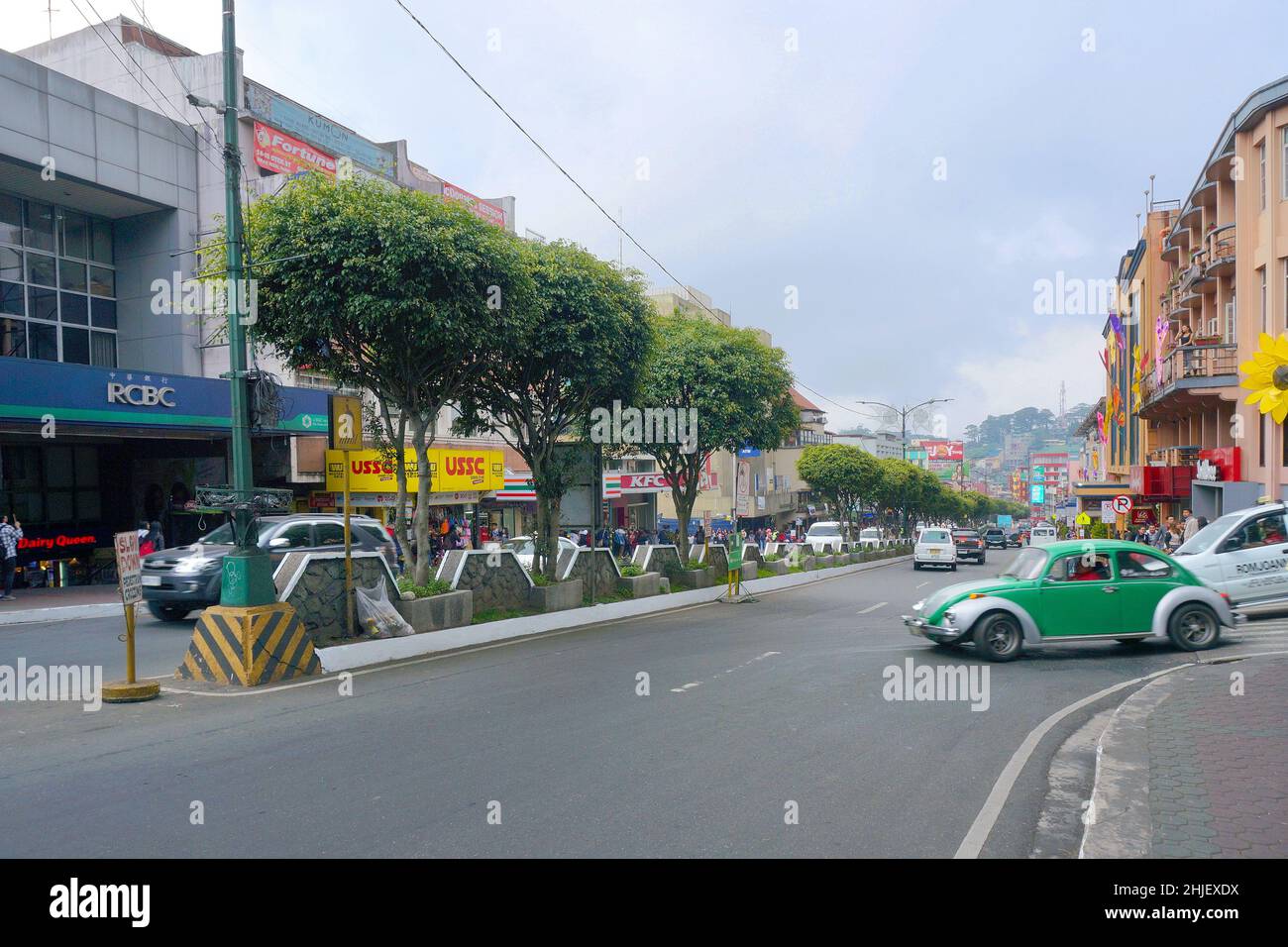 Urban road decorated with trees. Photo taken at Session Road in Baguio ...