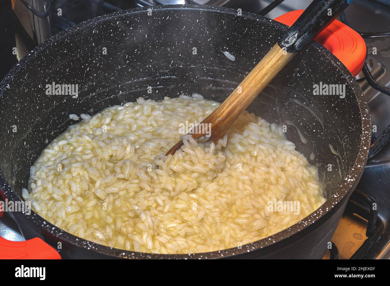 Rice Cooking In A Black Pan Stock Photo - Alamy