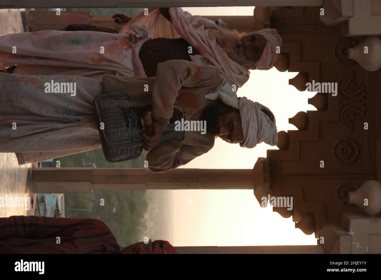 Vertical shot of local Indian people with colorful stains on their ...