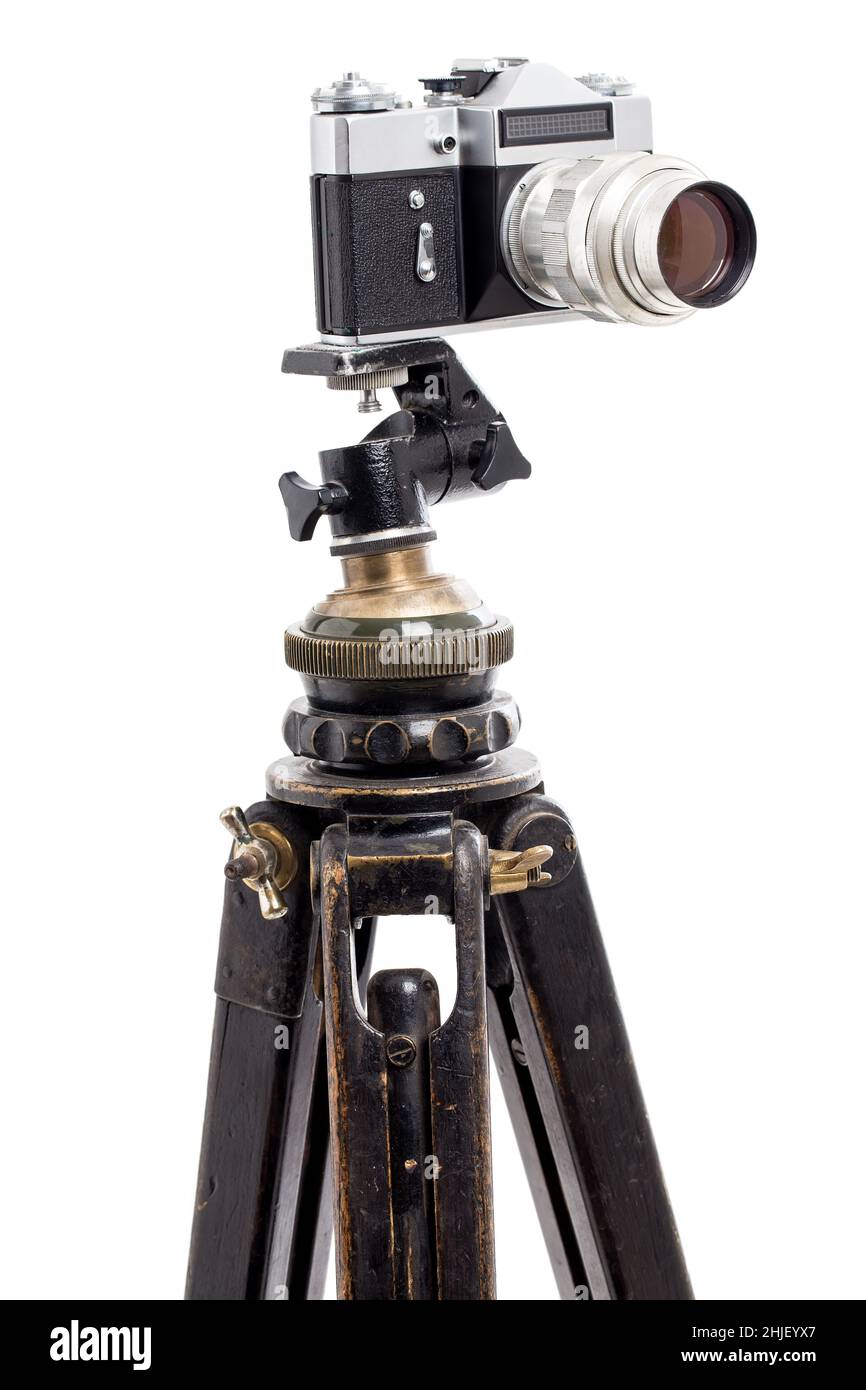 Old film photocamera on wooden tripod. Isolated on a white background ...