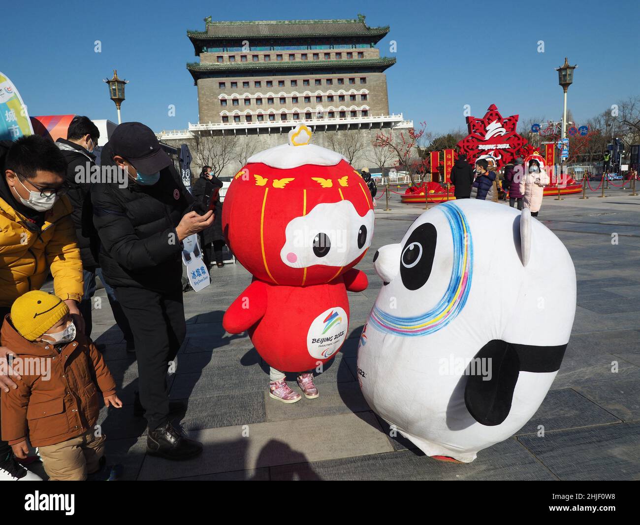 BEIJING, CHINA - JANUARY 29, 2022 - Tourists look at cartoon figures of ...
