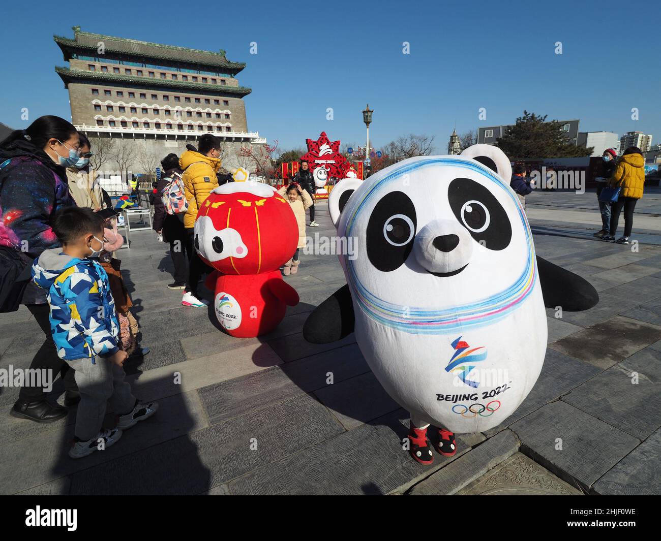 BEIJING, CHINA - JANUARY 29, 2022 - Tourists look at cartoon figures of Beijing Winter Olympic ...
