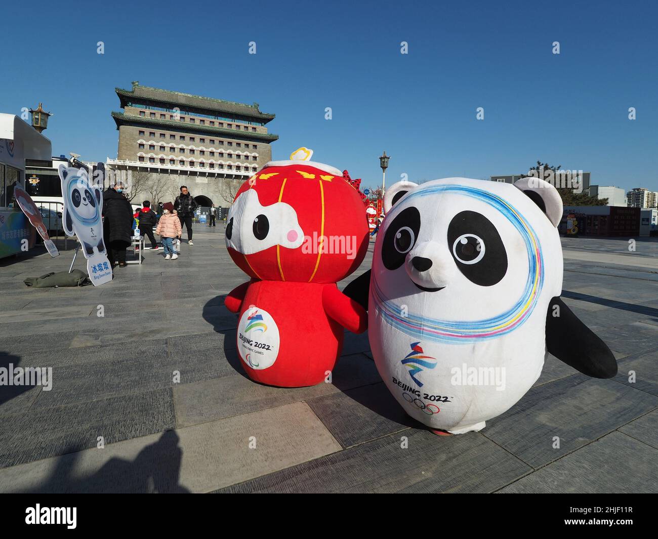BEIJING, CHINA - JANUARY 29, 2022 - Tourists look at cartoon figures of Beijing Winter Olympic ...