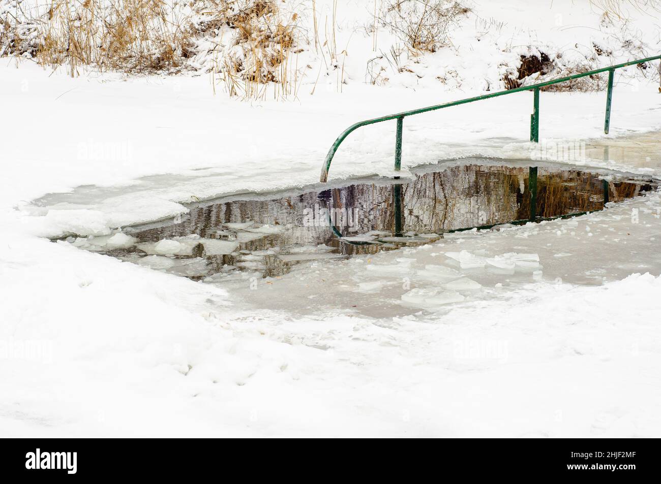 A hole in the ice of the lake for swimming in winter. Feast of the ...
