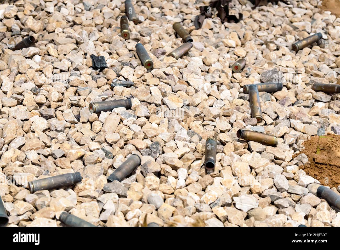 Empty bullet or cartridge casings spread on the ground. At the shooting ...