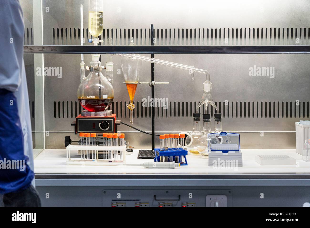 Biochemical laboratory. Scientists in a chemical protection suit create ...