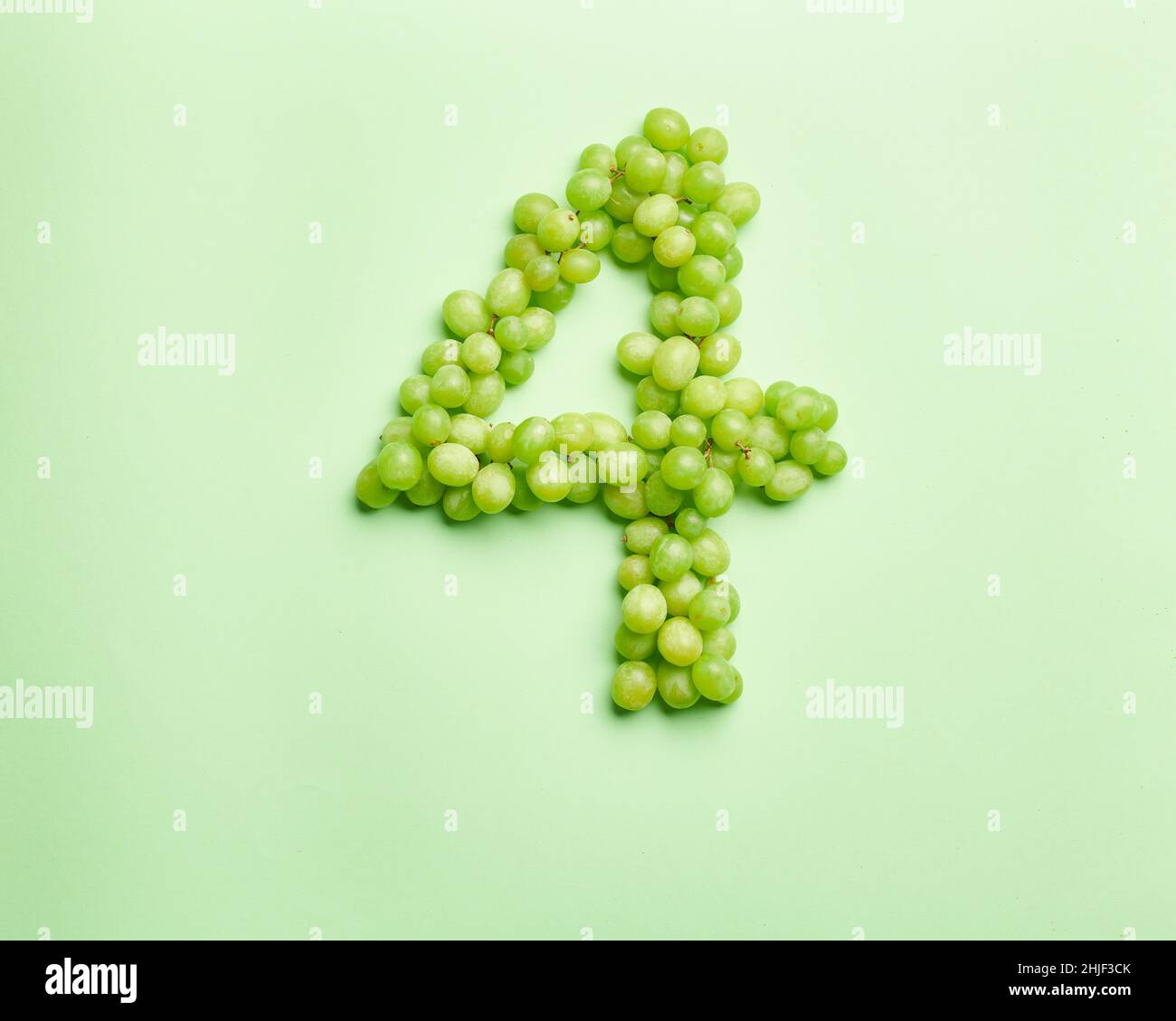 Bunches of green grapes. The number four formed by white grapes Stock ...
