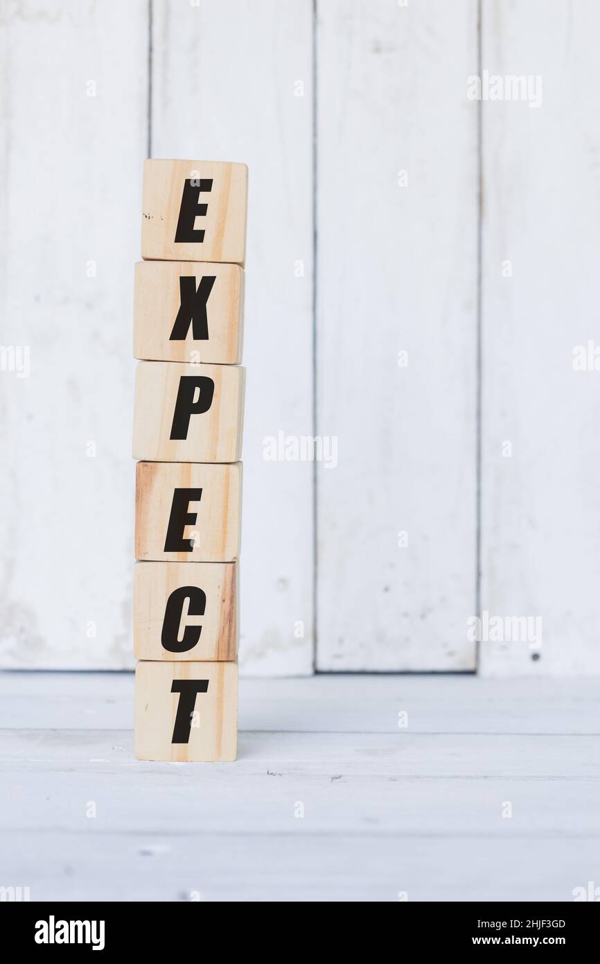wooden cube, with the word expect, with white wooden background Stock ...