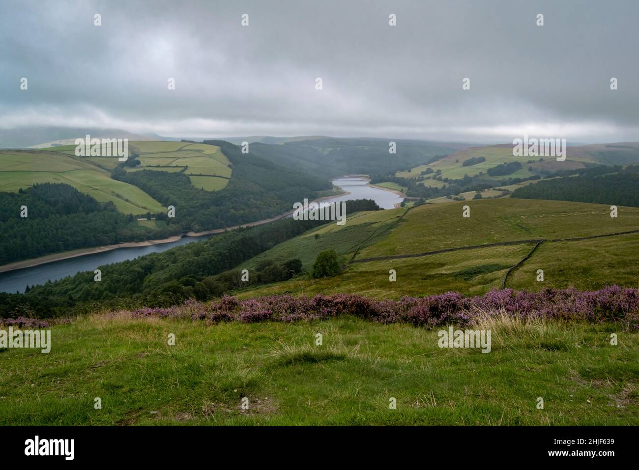 Vast landscape of Peak District hills covered with clouds and fog ...