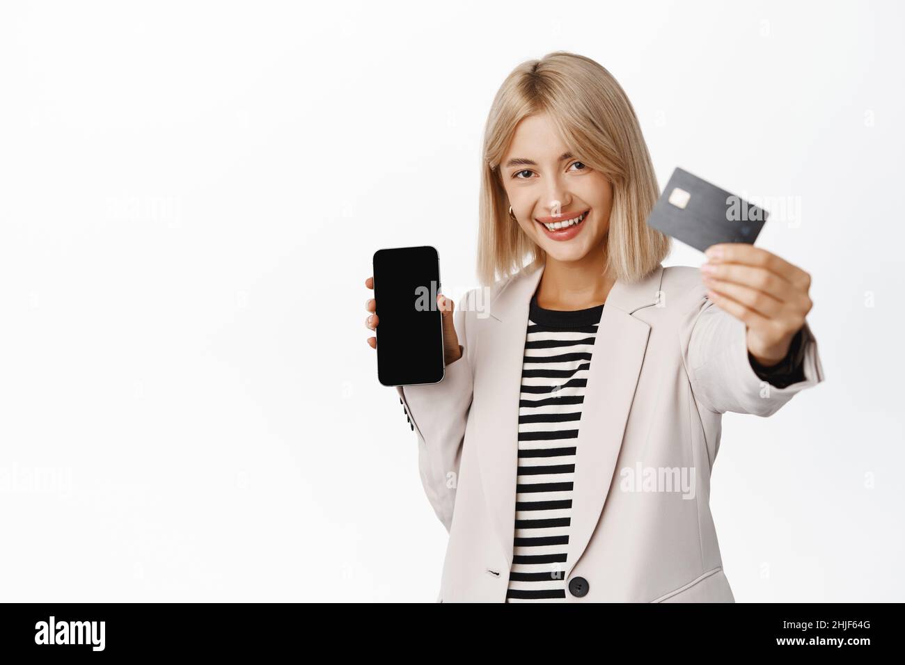 Smiling business woman extending hand, showing mobile phone screen, app ...