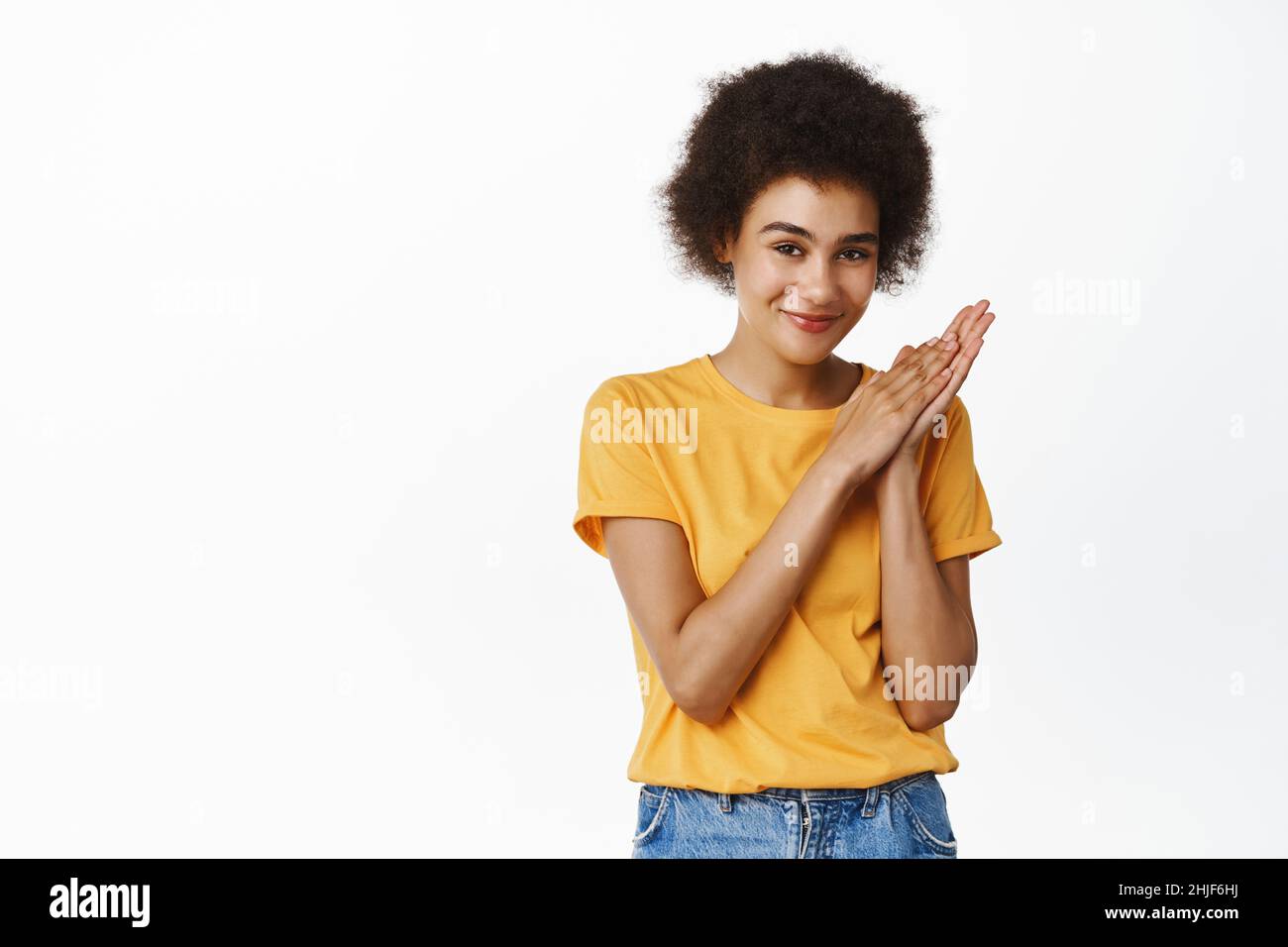 Image of cunning african woman clap hands, smiling and looking devious ...