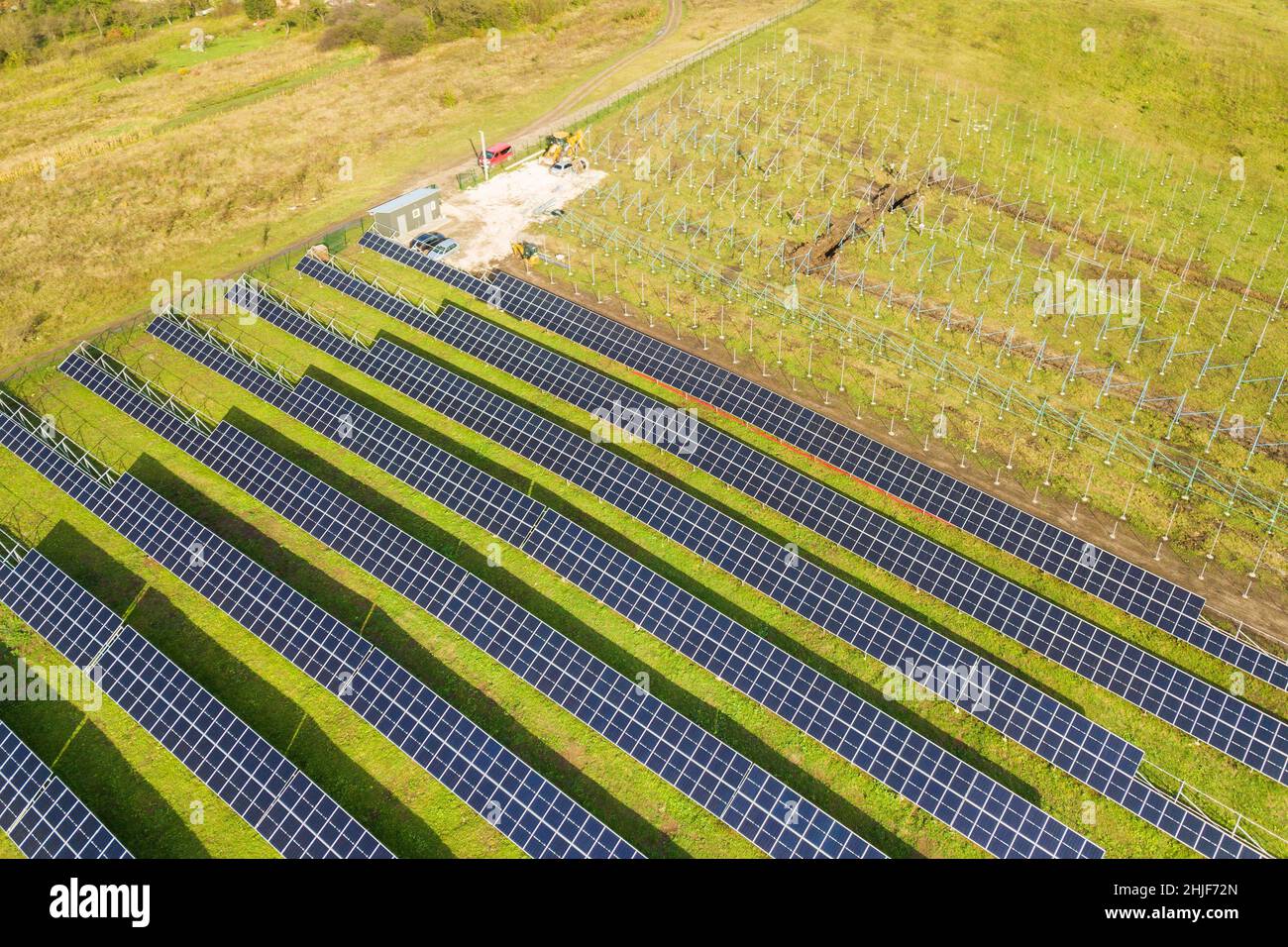 Aerial view of solar power plant under construction on green field ...