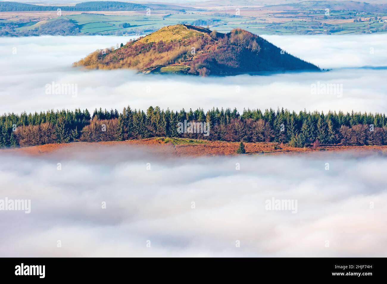 Mountains and trees showing through low level fog and cloud inversions ...