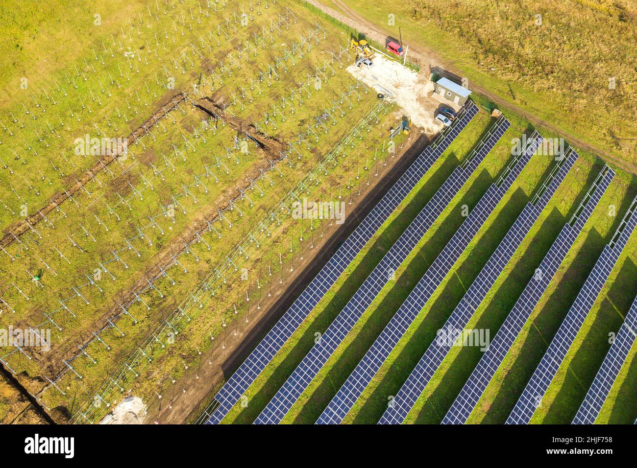 Aerial view of solar power plant under construction on green field ...