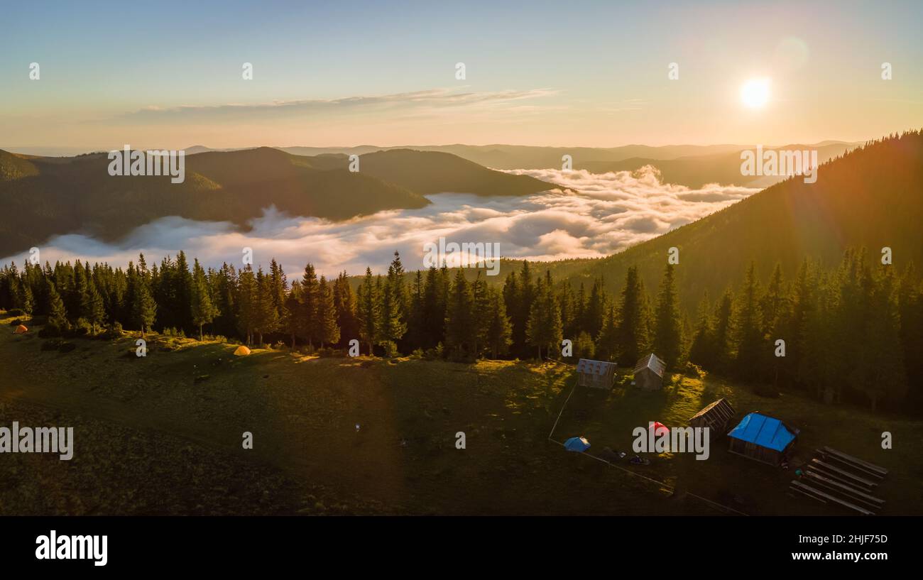 Aerial view of tourist camping tents on mountain campsite at bright ...