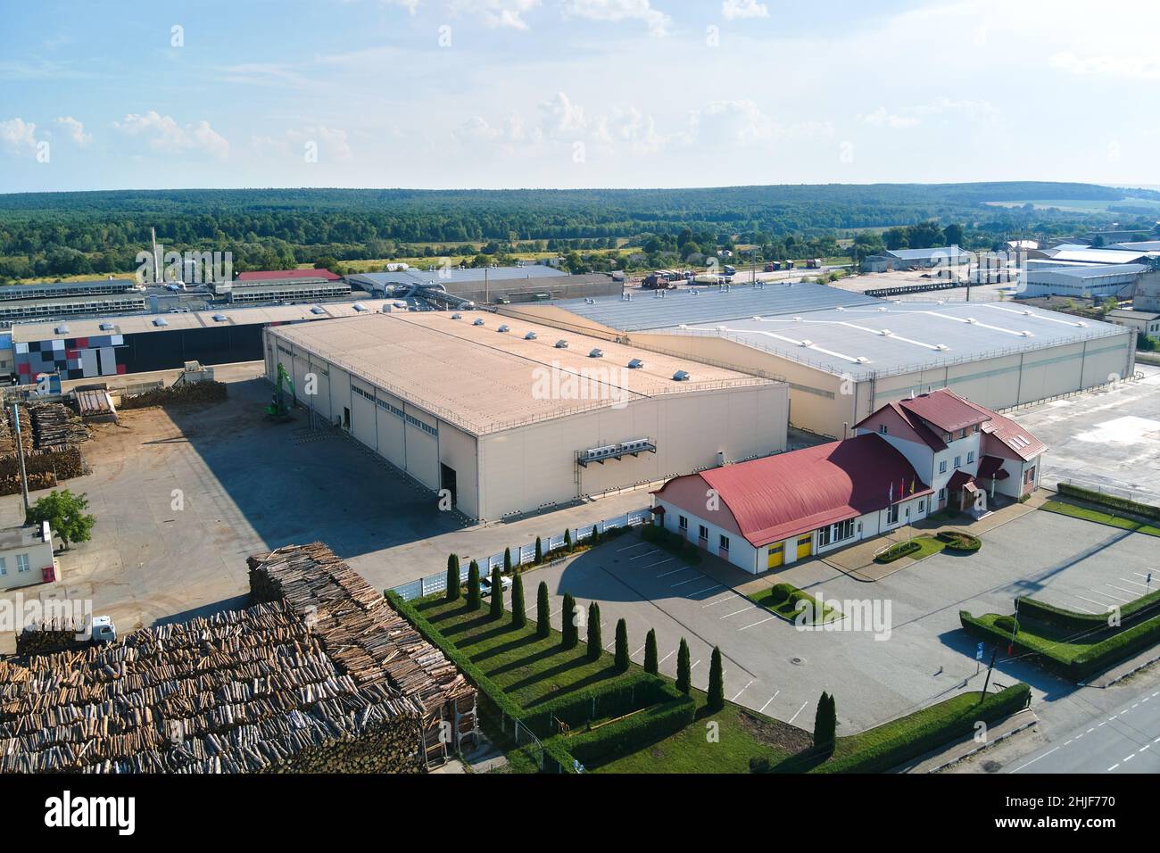 Aerial view of wood processing factory with stacks of lumber at plant ...