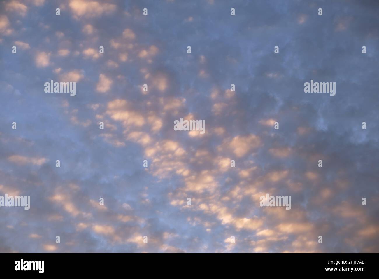 Bright colorful sunset sky with vivid smooth clouds illuminated with ...