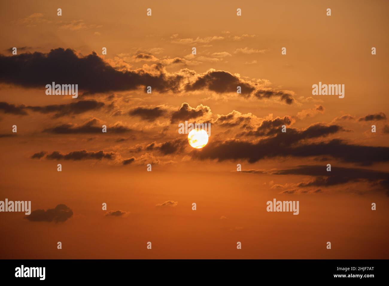 Bright colorful sunset sky with rays of setting sun and vivid dark ...