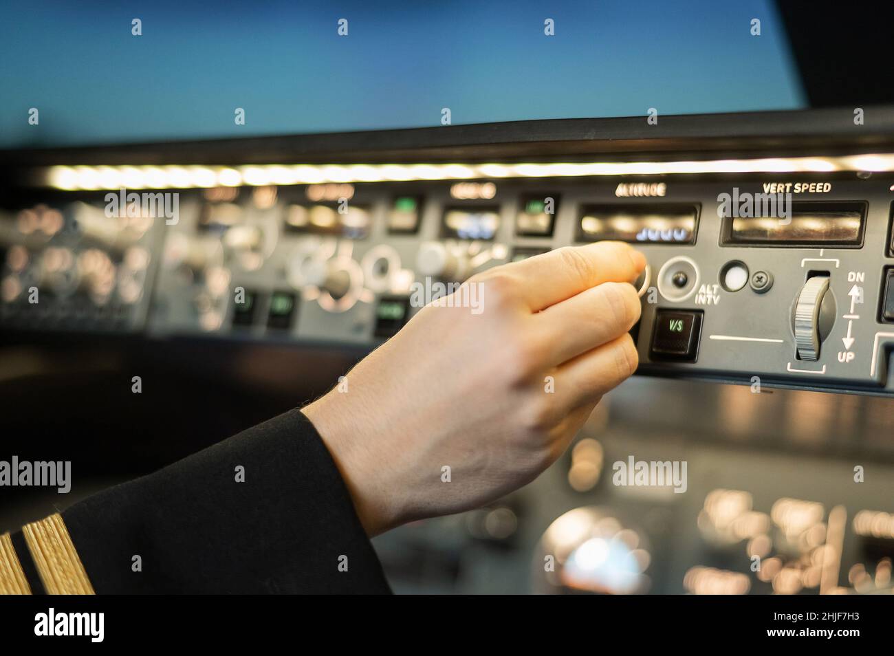 Close-up of a pilot's hand on an airplane control panel Stock Photo - Alamy