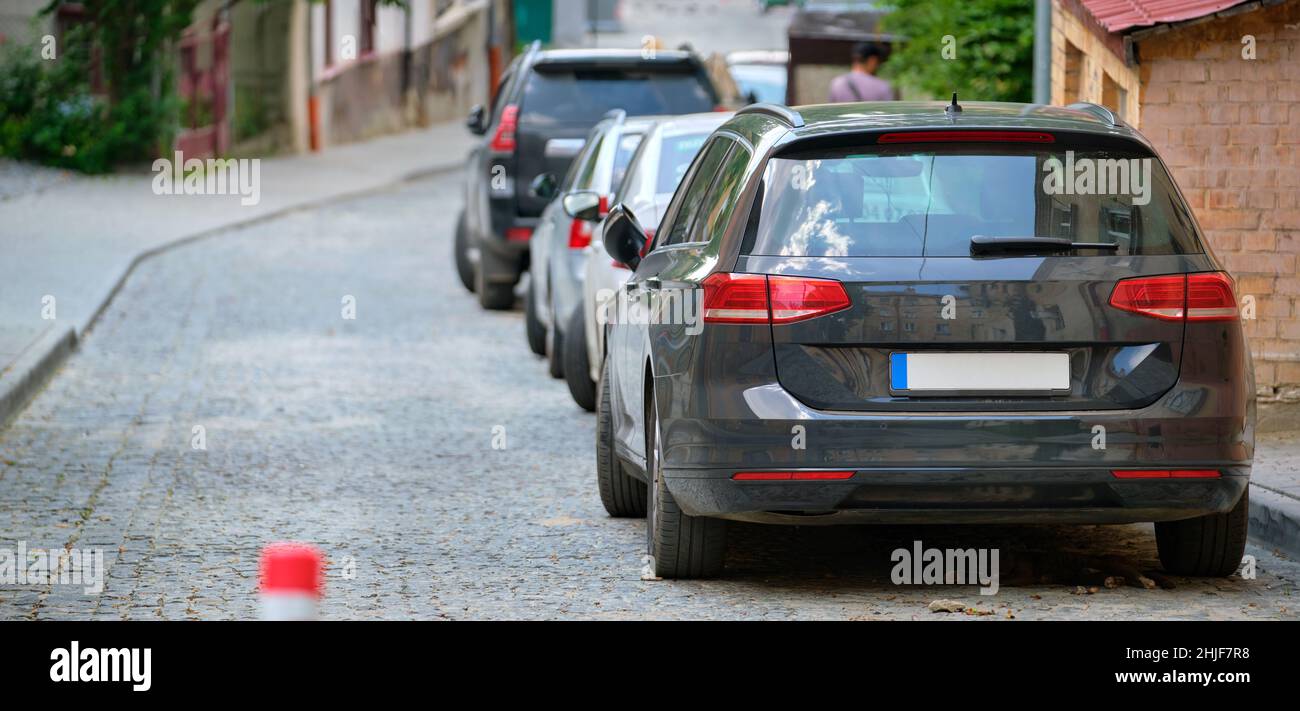 City traffic with cars parked in line on street side Stock Photo - Alamy