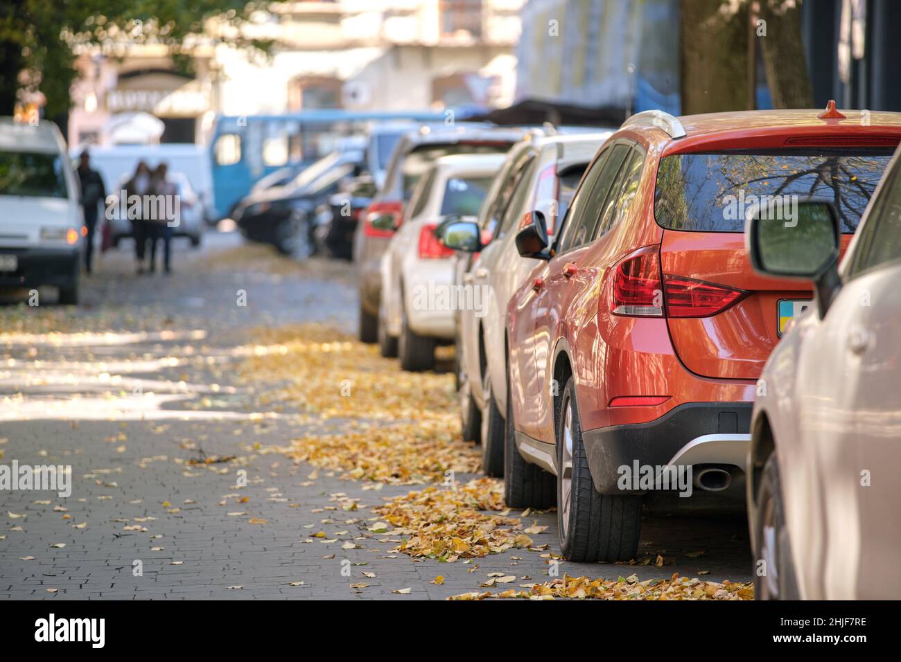City traffic with many cars parked in line on street side Stock Photo ...