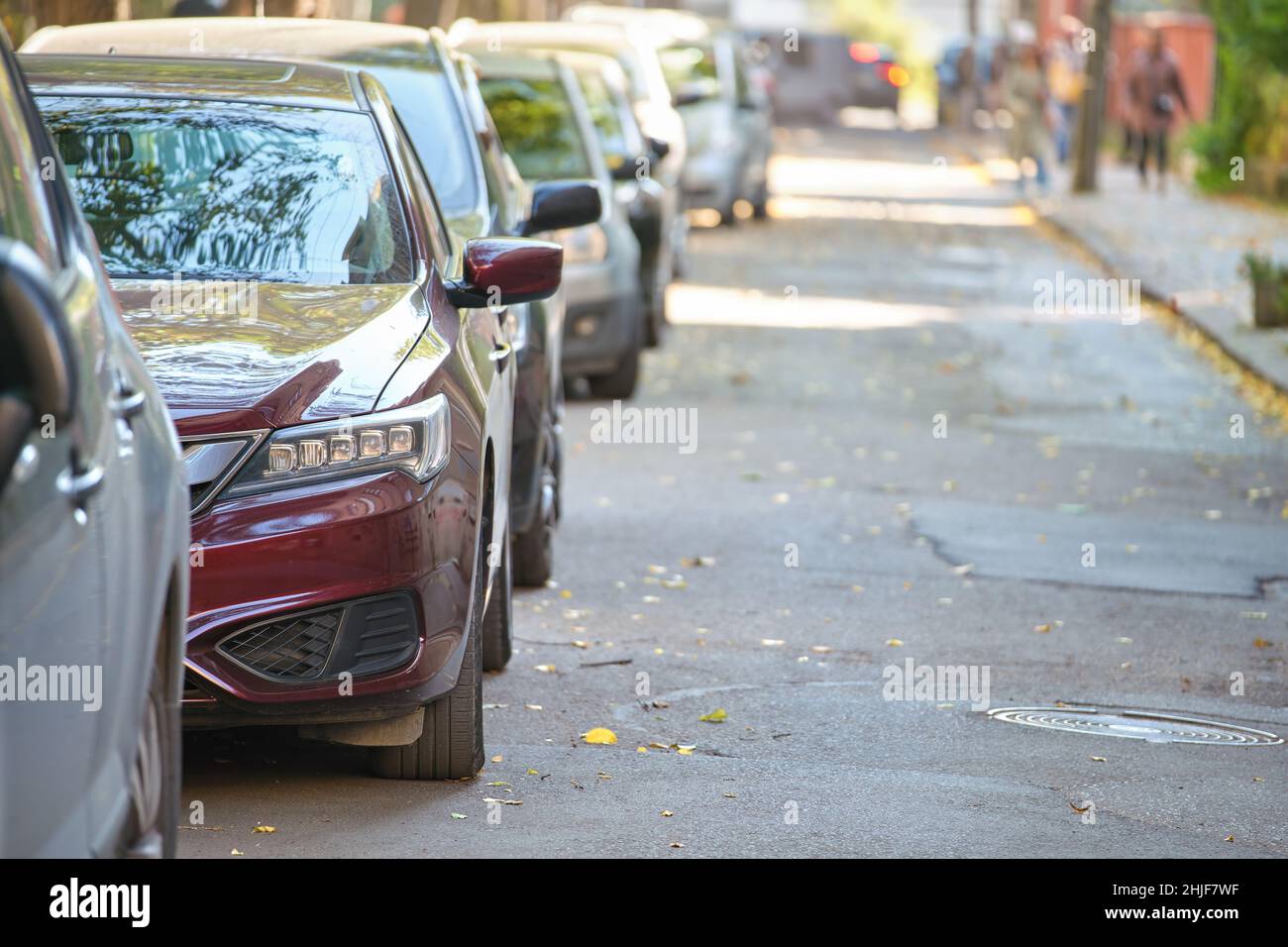 City traffic with many cars parked in line on street side Stock Photo ...