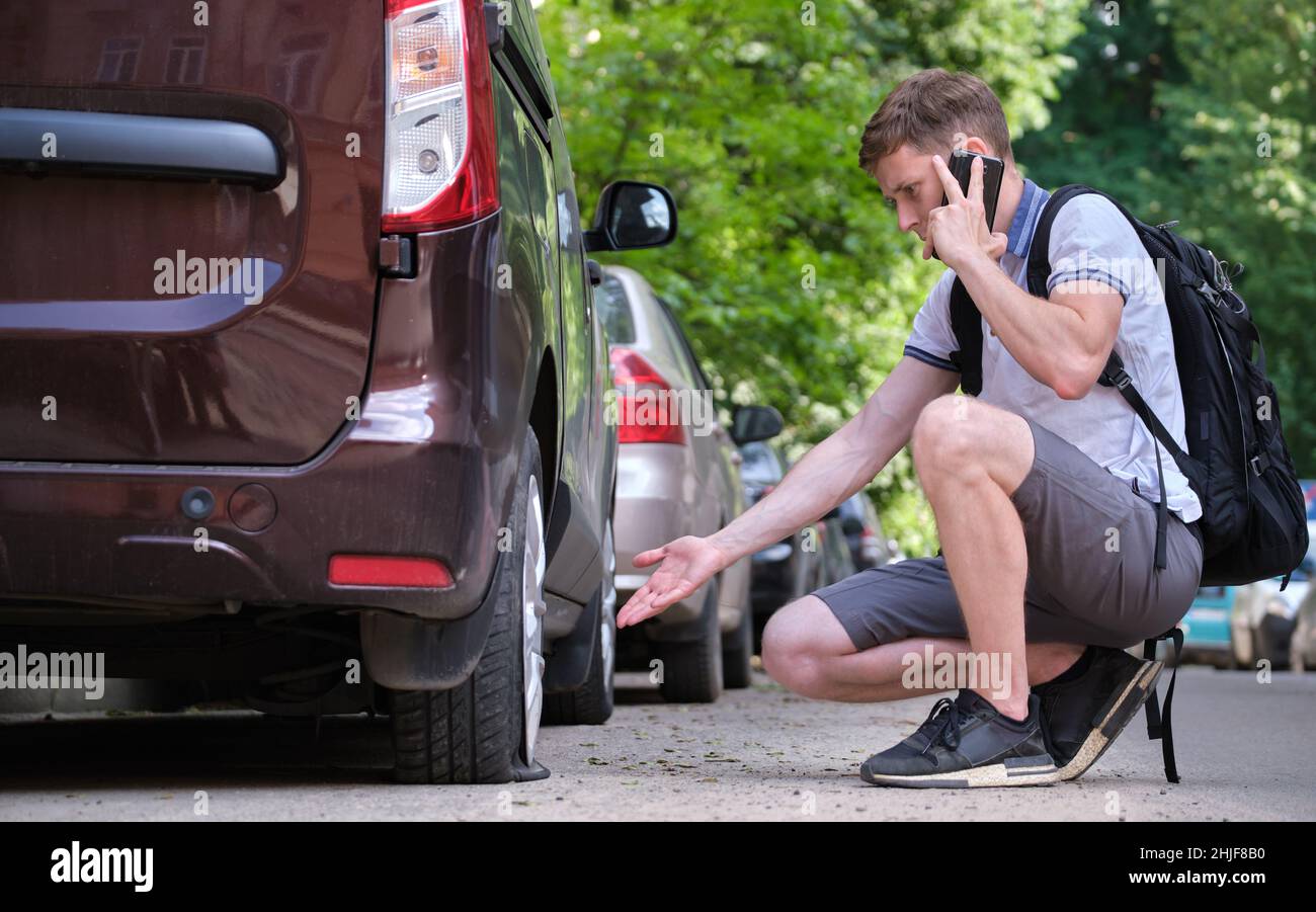 Driver calling road service for assistance having vehicle trouble with ...