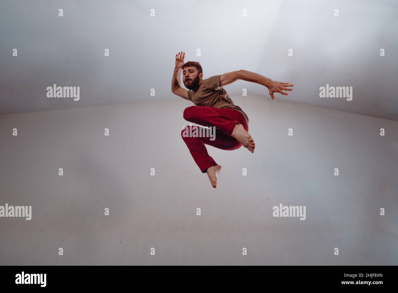 Muscular dance performer practicing dance moves at the studio Stock ...